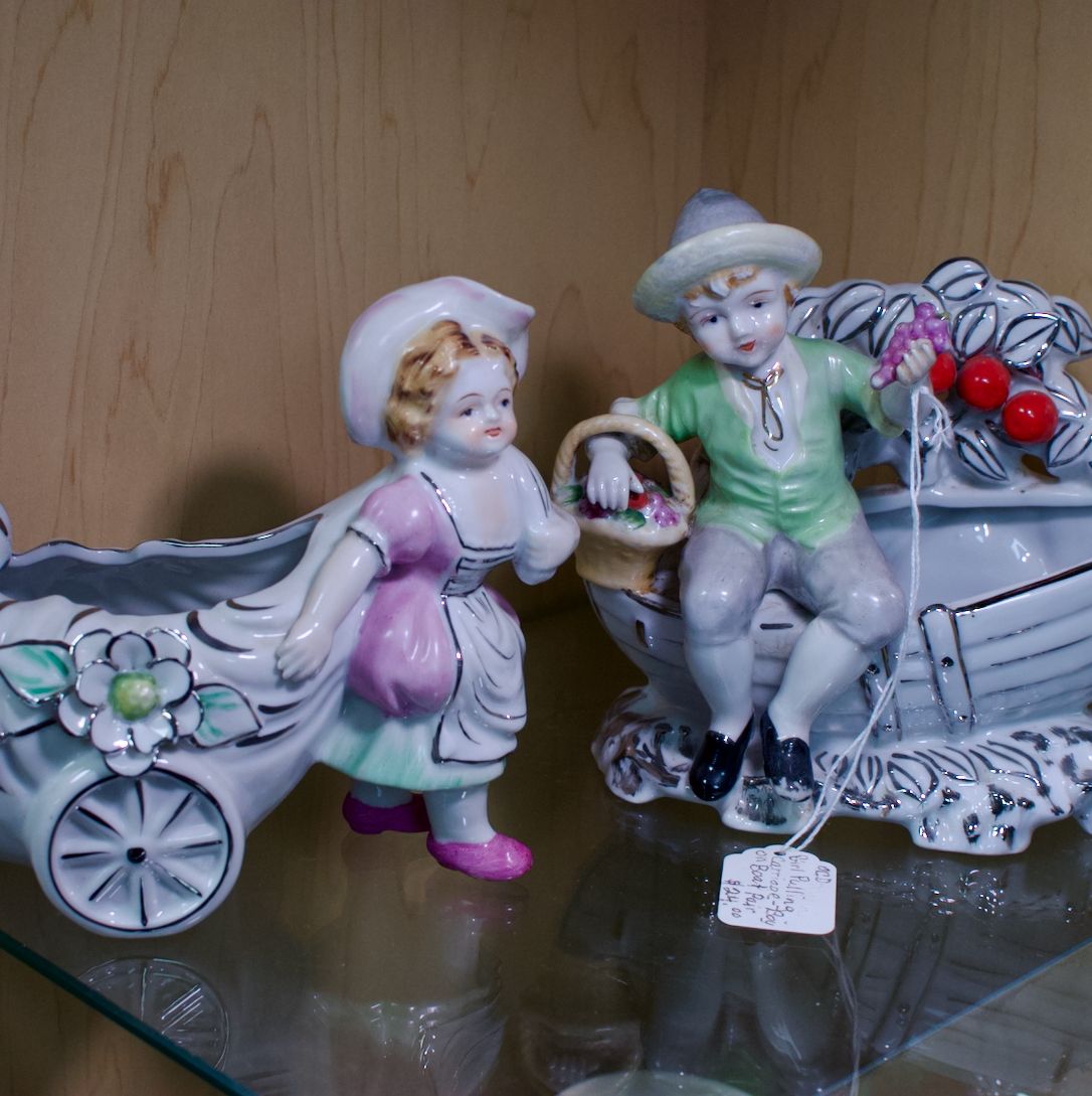 Girl pulling carriage - boy on boat pair